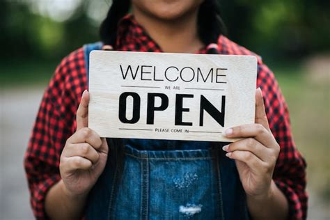 Premium Photo Midsection Of Woman Holding Open Sign Board