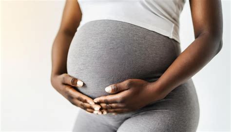 Premium Photo Pregnant Womans Belly And Genital Area In Light Grey