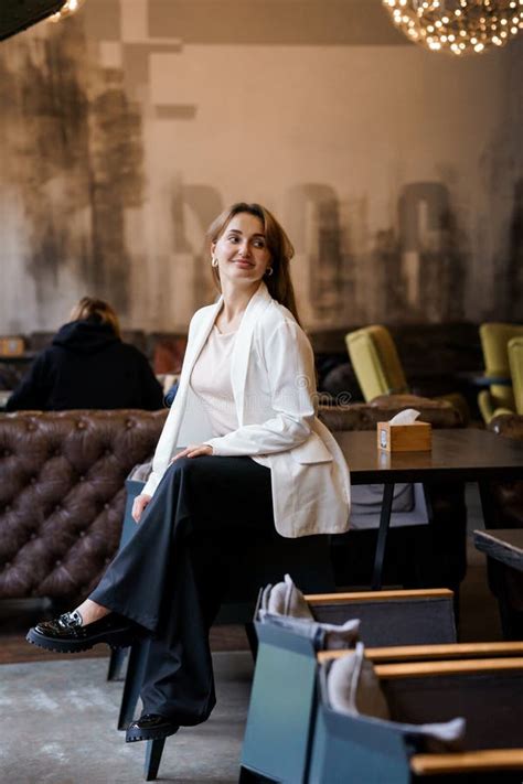 Elegant Woman Posing In A Chic Cafe Setting Stock Photo Image Of Artistic Fashionable