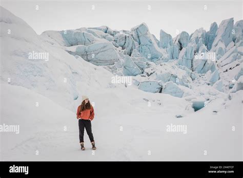Teenage Girl Standing On The Matanuska Glacier In The Middle Of Blue