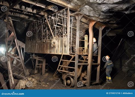Inside A Coal Mine With Miners Using And Drilling Equipment To Extract