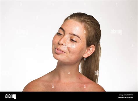 Pretty Girl With Freckles Looks Away With Her Hair Tied Up In Front Of