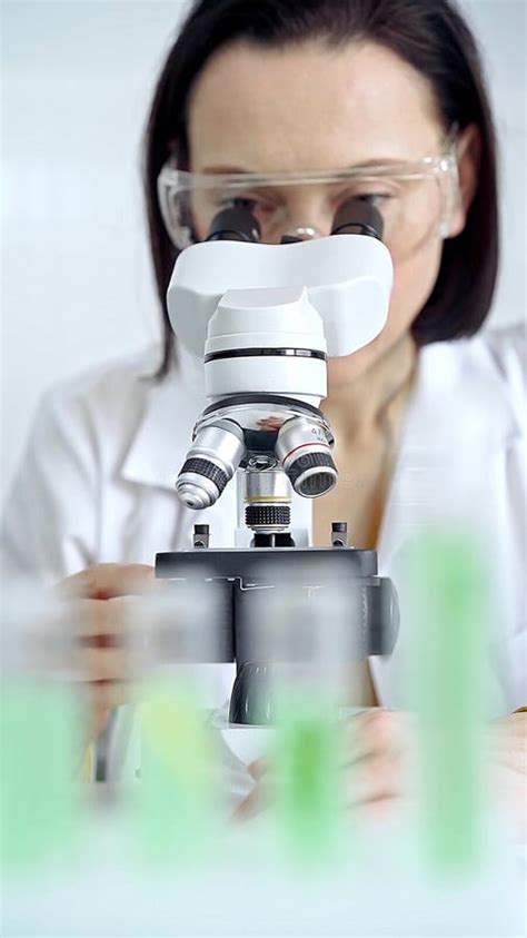 Woman Scientist Using Microscope In Laboratory Microbiology Science