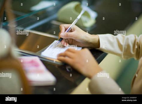 Women S Hands Writing In A Check Book Stock Photo Alamy