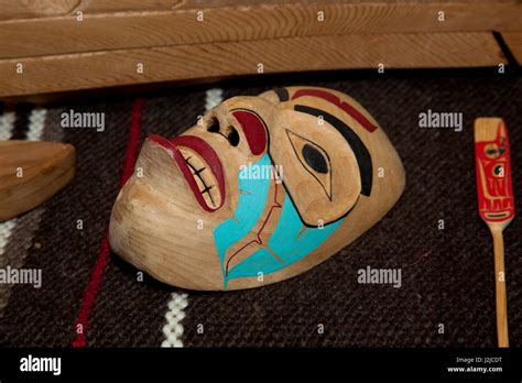 Carved Cedar Wood Ceremonial Human Mask Displayed On Wool Blanket