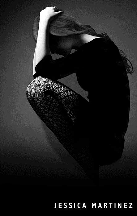 A Woman Sitting On The Ground With Her Hands Behind Her Head In Black