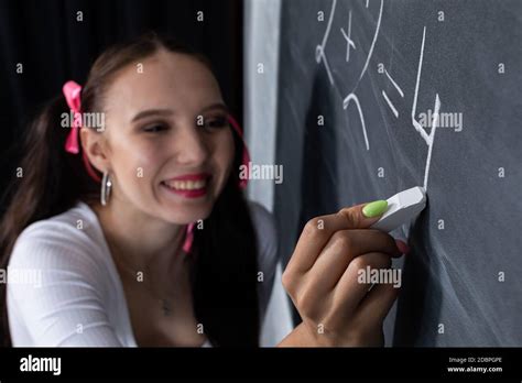 A Young Schoolgirl Writes On The Blackboard School Math Lesson He
