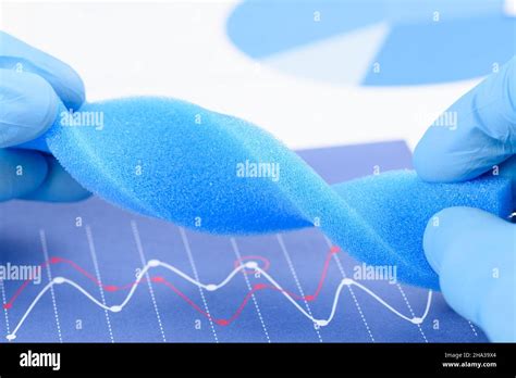 Blue Porous Foam Material Twisted In Scientist Hands In Laboratory Research For Material With