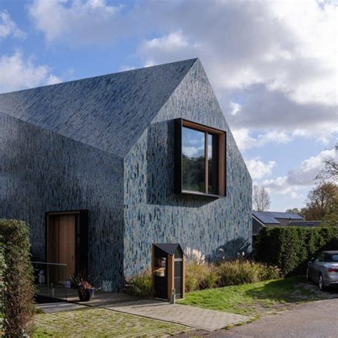 Glossy Ceramic Tiles In Shades Of Green And Blue Cover The Twisting