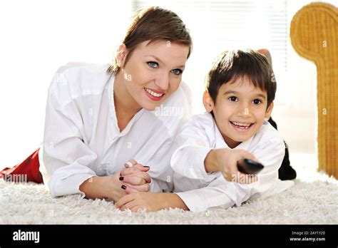 Mom With Son Lying On Floor And Watching Tv Using Remote Control Stock Photo Alamy