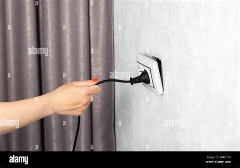 The Girl Incorrectly Removes The Electric Plug From The Socket And Breaks The Socket Danger Of