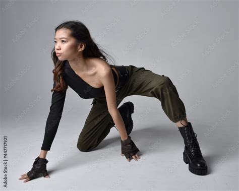Full Length Portrait Of Pretty Brunette Asian Girl Wearing Black Top
