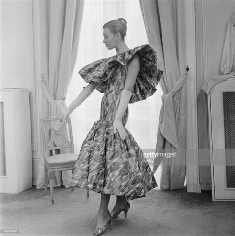 A Model Wearing A Green Print Silk Cocktail Dress With A Vast