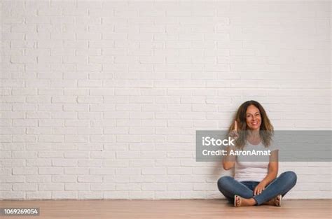 흰색 벽돌 벽 아이디어 놀된 동안 나이 히스패닉 여자 중간 또는 행복 한 얼굴 넘버 원 가리키는 손가락 질문 가리키기에 대한 스톡 사진 및 기타 이미지 Istock