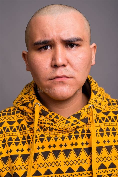 Young Bald Asian Man Against Gray Background Stock Image Image Of