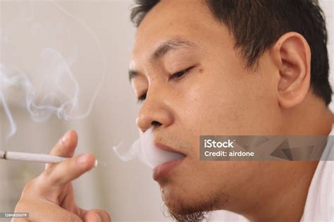 Close Up Of A Man Smoking Cigarette Inhale And Exhaling Smoke From His