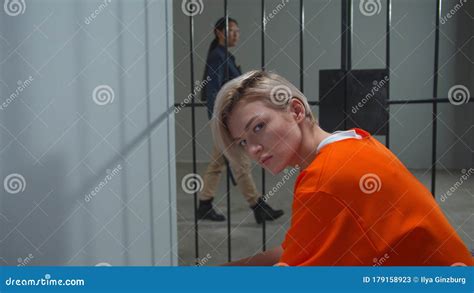 Female Jailer Leads A Criminal In Her Cell Royalty Free Stock Image
