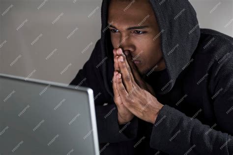 Premium Photo Close Up Of An African American Hacker In A Hoodie Plotting His Next Attack
