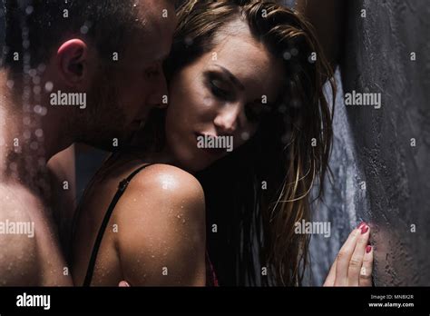 Shot Of A Beautiful Woman Taking A Shower And Her Partner Standing Behind Her Stock Photo Alamy