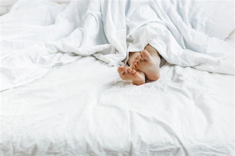 Premium Photo Female And Male Feet Under The Bed Sheet Sex Concept