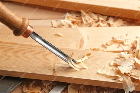 Premium Photo Working With Chisel And Wooden Board In Carpenters Shop Closeup