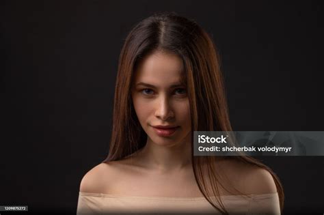 Portrait Of Beautiful Longhaired Brunette Girl On Black Background