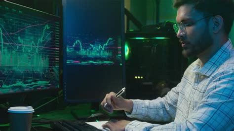 Indian Arabian Man Writing Notes Notebook Working With Pc Computer Trader Programmer Coder