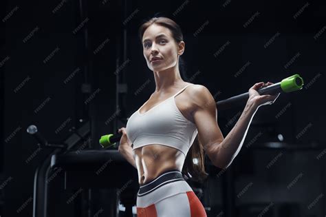 Premium Photo Athletic Fitness Woman At Workout In Gym With Body Bar