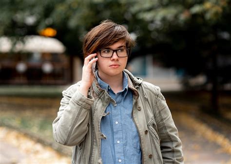 Premium Photo Non Binary Person With Glasses Talking On The Phone