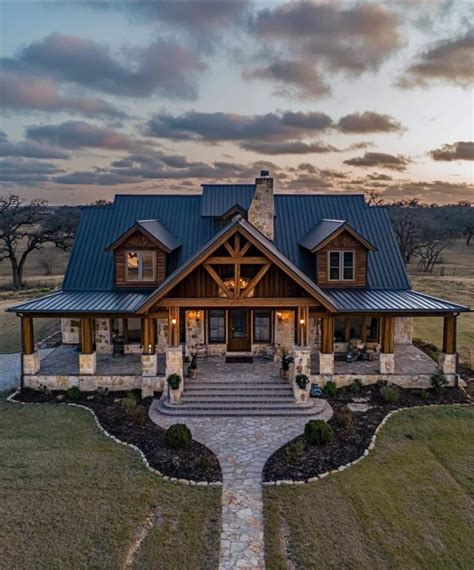 Front View Of A Barndominium With Large Glass Windows And Wooden Beams
