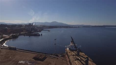 4k Drone Footage Of A Logging Port With A Ship Being Loaded With Logs