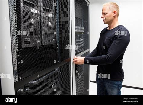 Computer Engineer Opening Server Rack Door In Data Center Stock Photo Alamy