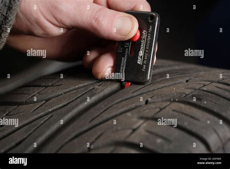 Control Of The Tyre Tread With A Measuring Tool Stock Photo Alamy