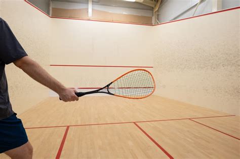 Unrecognizable Man Waving A Squash Racket Inside Court Stock Image