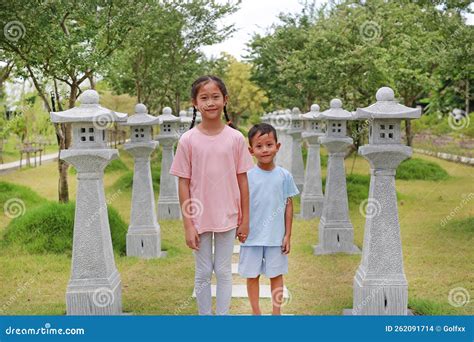 Portrait Of Asian Sister And Little Brother With Hand In Hands At