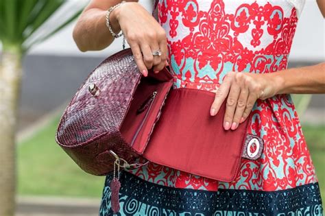 Premium Photo Girl Holding A Bag Made Of Handmade Python Skin