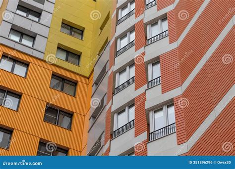 Angled View Of A Modern Building Facade With Orange Cladding And Windows For Architectural