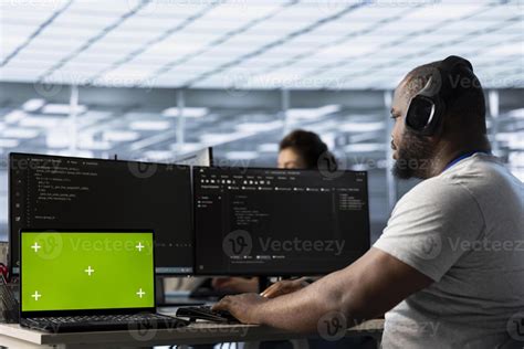 Isolated Screen Laptop In Front Of It Support Workers Coding On Computers And Listening Music