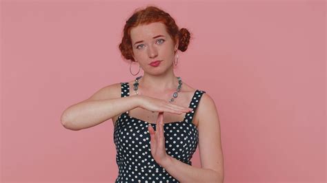 Tired Serious Upset Young Redhead Woman In Dress Showing Pause Gesture Limit Or Stop Sign Time