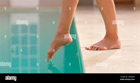 Testing The Waters An Unrecognizable Woman Sticking Her Foot In A Pool