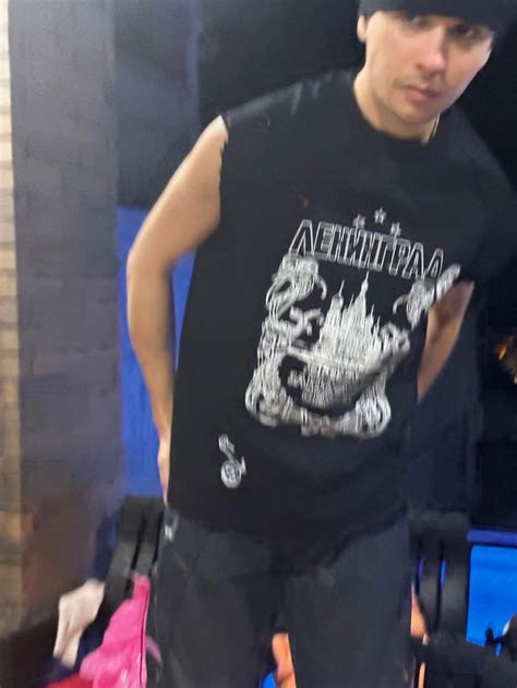 A Young Man Standing In Front Of Luggage
