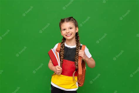 Premium Photo Learning German A Schoolgirl With A Textbook And An Image Of The German Flag On