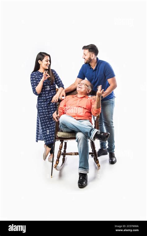 Indian Old Man Or Father With Young Son And Daughter Sitting Over
