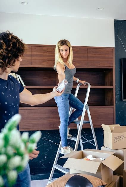Premium Photo Couple Adjusting Objects At New Home
