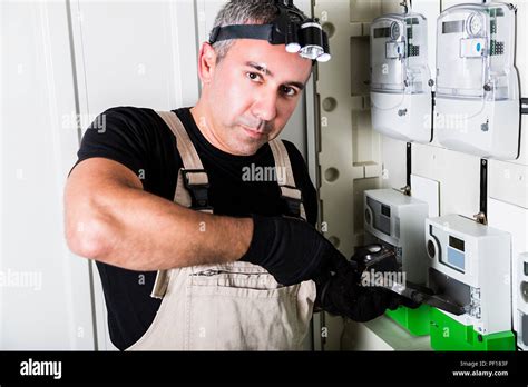 Electrician Testing Fuse Box Or Switch Box With Flashlight On Head Close Up Stock Photo Alamy