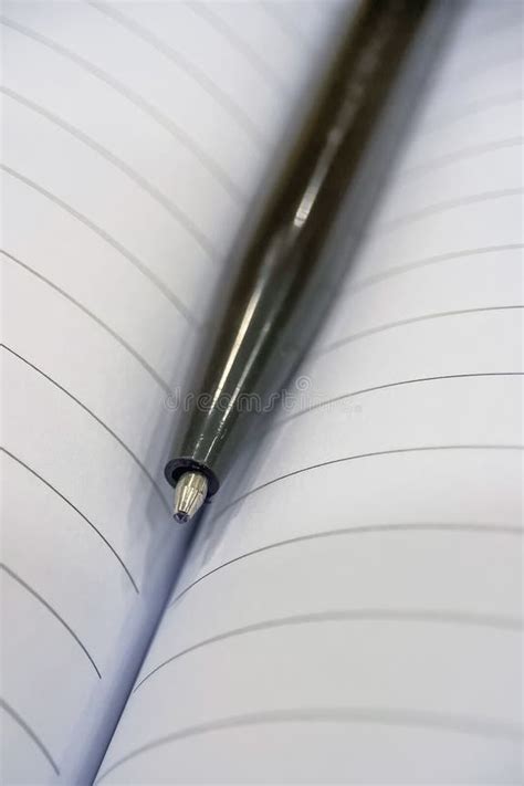 Knowledge At Your Fingertipscaptured By A Sleek Pen Resting In An Open