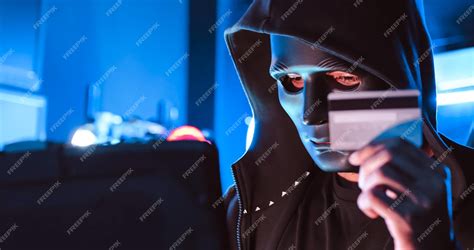 Premium Photo A Hacker Wearing A Mask To Cover His Face Is Using