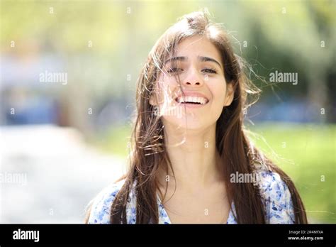 Front View Portrait Of A Happy Woman Laughing With Tousled Hair A Windy