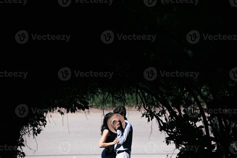 Couple Jumping In The End Of Tunnel With Trees Stock Photo At Vecteezy