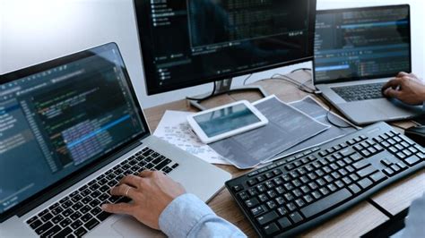 Premium Photo Midsection Of Programmer Working On Table